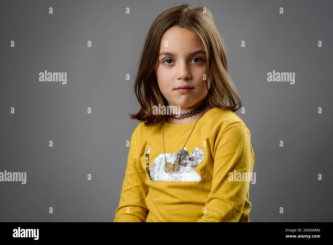 Portrait of happy young little girl with emotions on gray. Portrait of ...