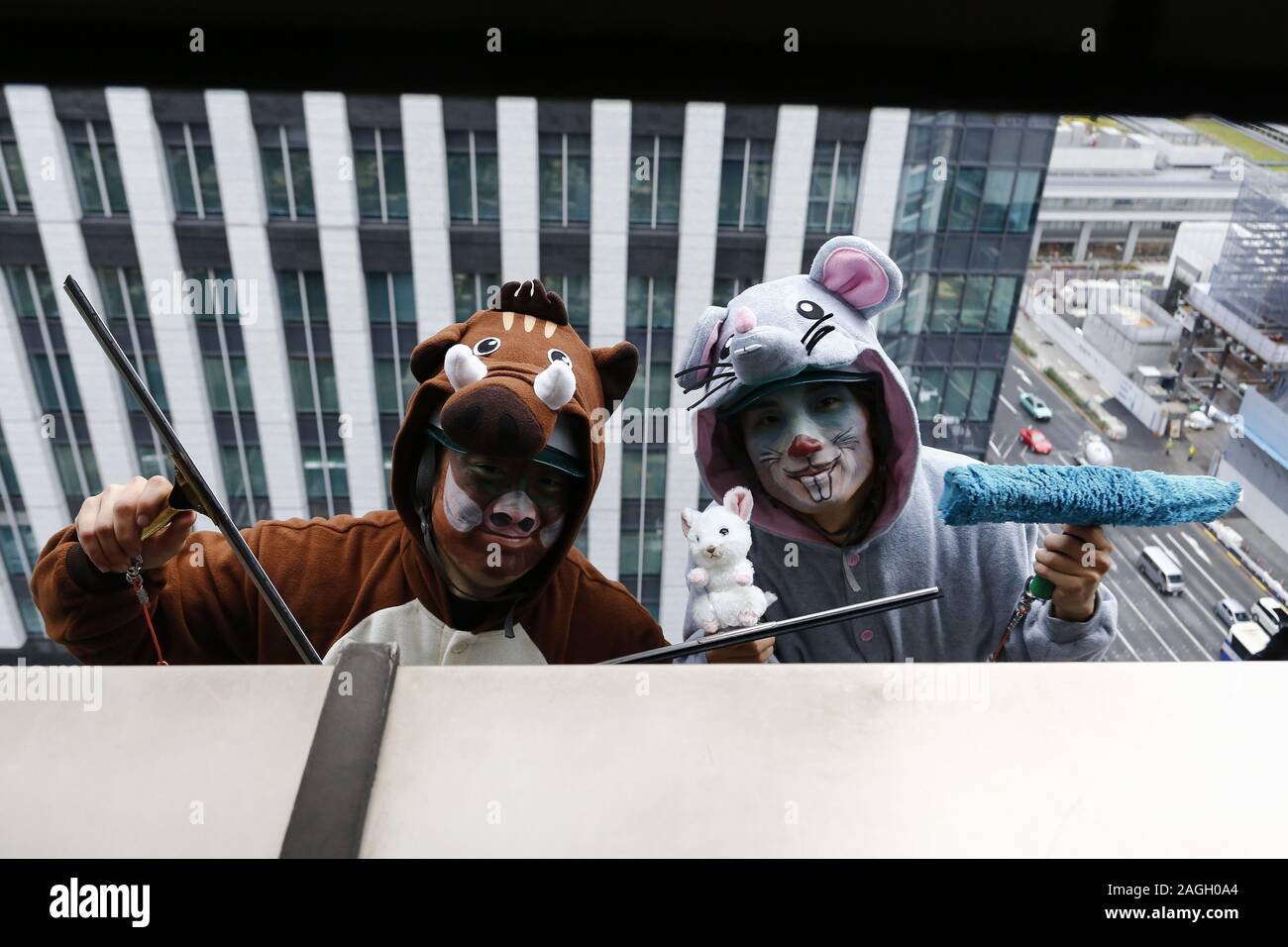 Tokyo, Japan. 19th Dec, 2019. Window cleaners dressed as a wild boar ...