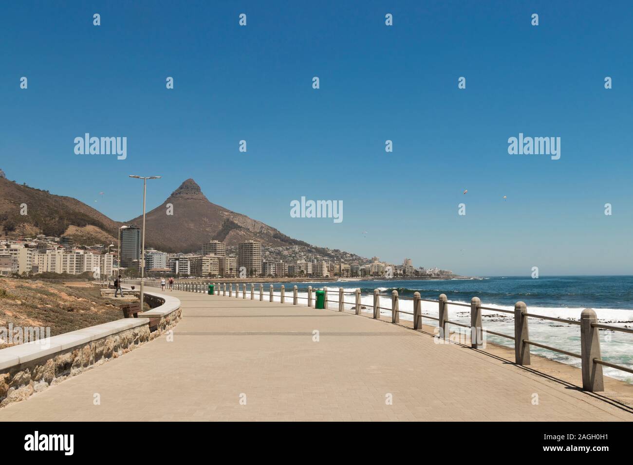 Mountains, hotels and deep blue water with waves at the Sea Point ...