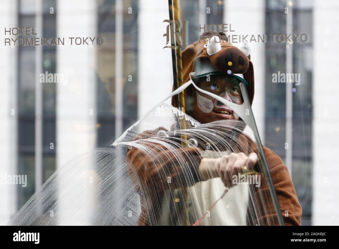 Tokyo, Japan. 19th Dec, 2019. A window cleaner dressed as a wild boar ...