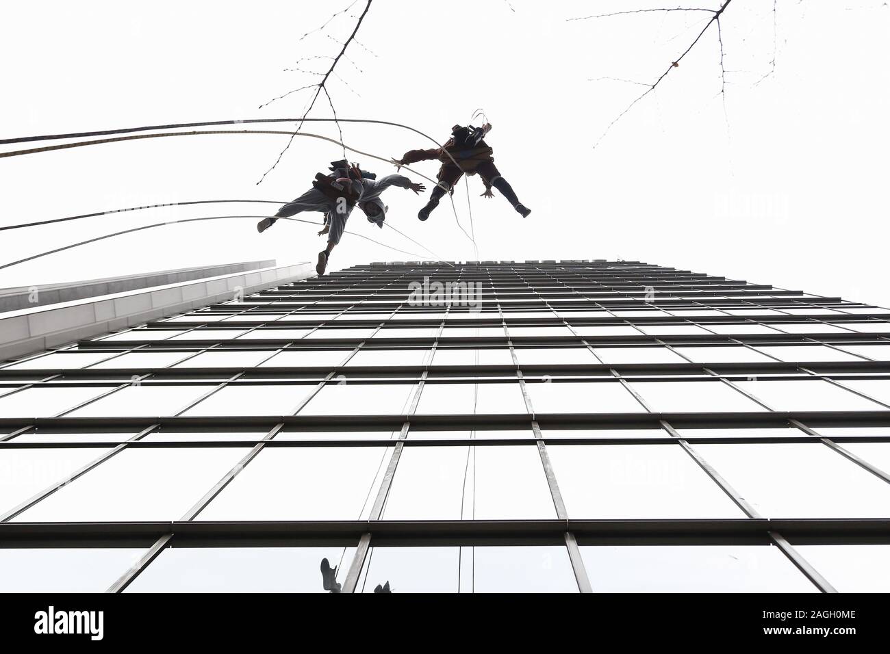 Tokyo, Japan. 19th Dec, 2019. Window cleaners dressed as a wild boar ...