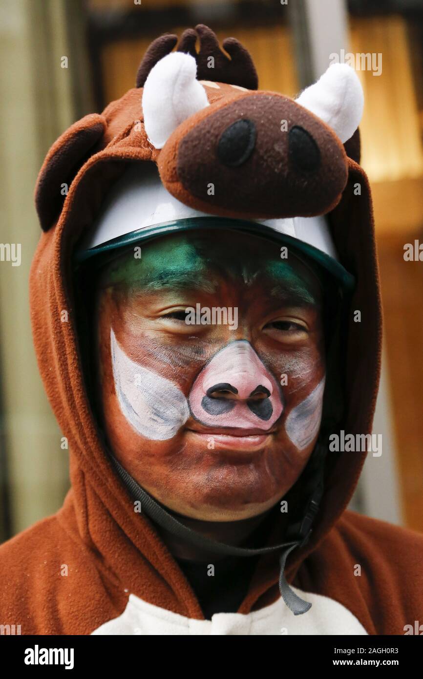 Tokyo, Japan. 19th Dec, 2019. A window cleaner dressed as a wild boar ...