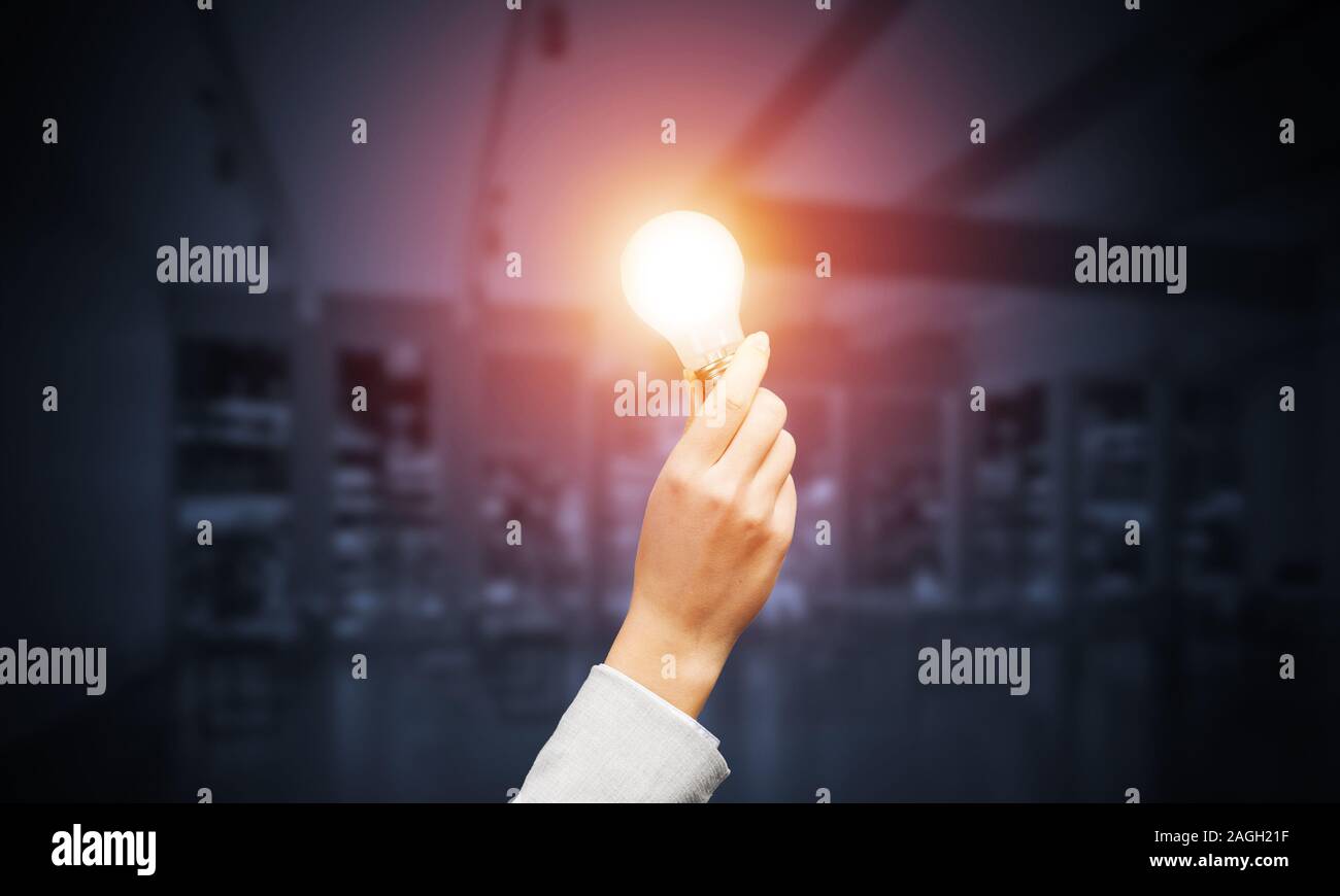 Human hand with glowing incandescent lamp Stock Photo - Alamy