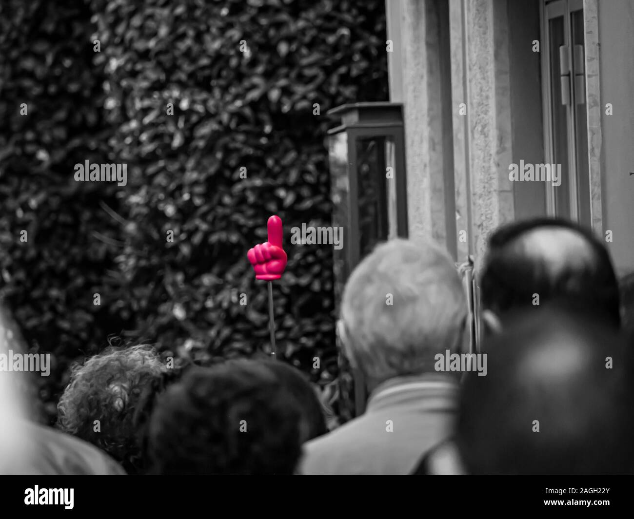 Tourists following a rubber finger indicating the position of the guide ...