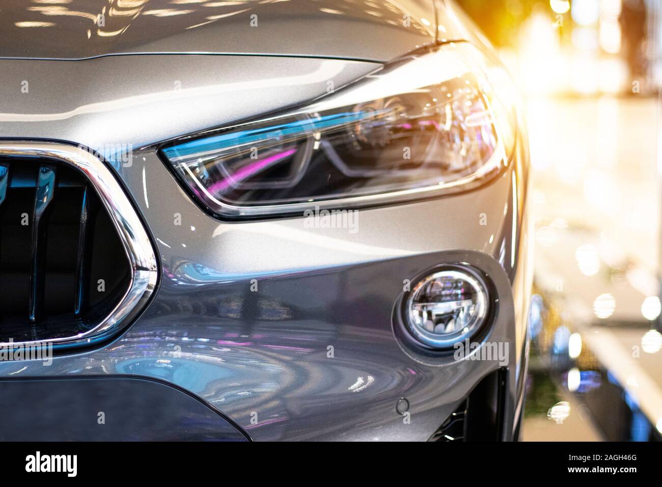 Modern, shiny car headlight in a car showroom Stock Photo - Alamy