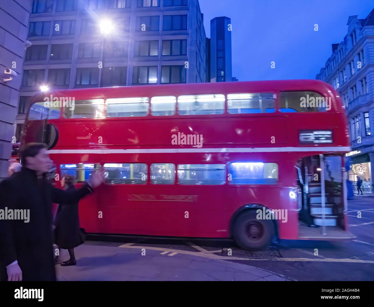 Old style London Routemaster red bus outside the Rttz Hotel Piccadilly ...
