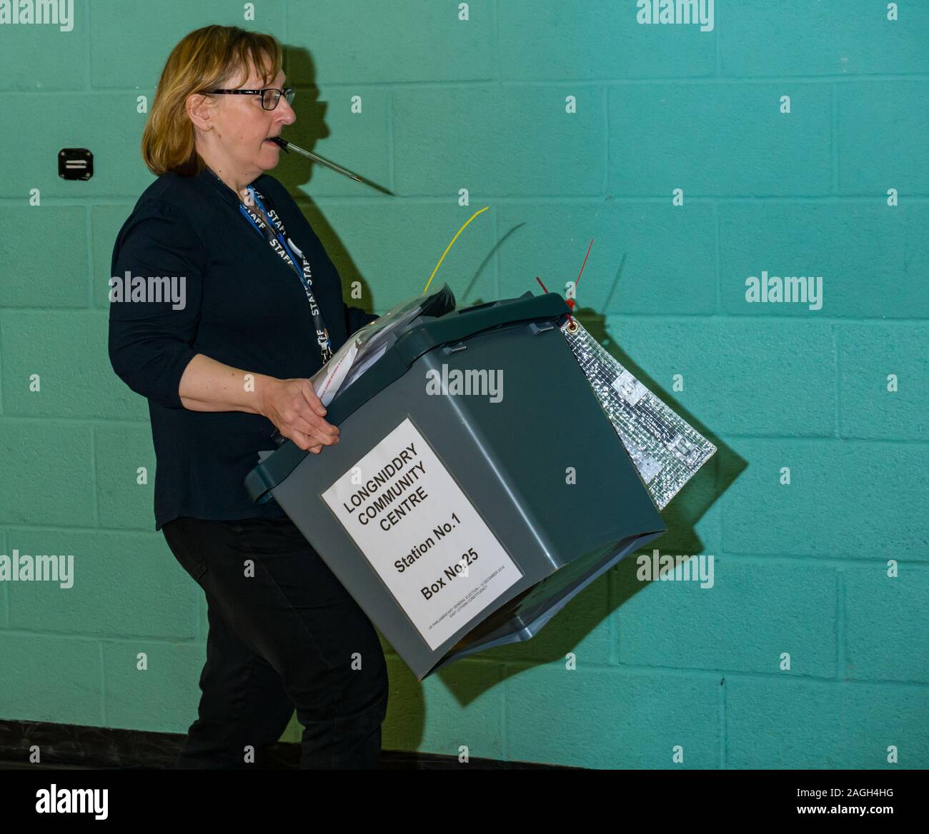 Returning officer staff carrying ballot box at the general election ...