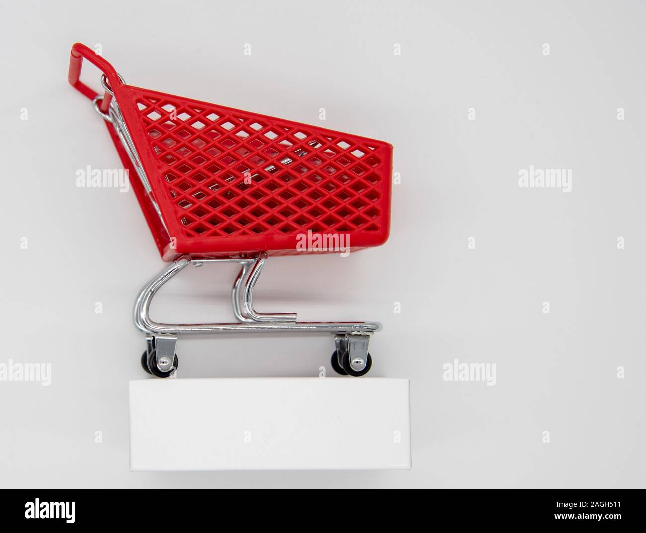 An empty supermarket cart on a light background Stock Photo - Alamy