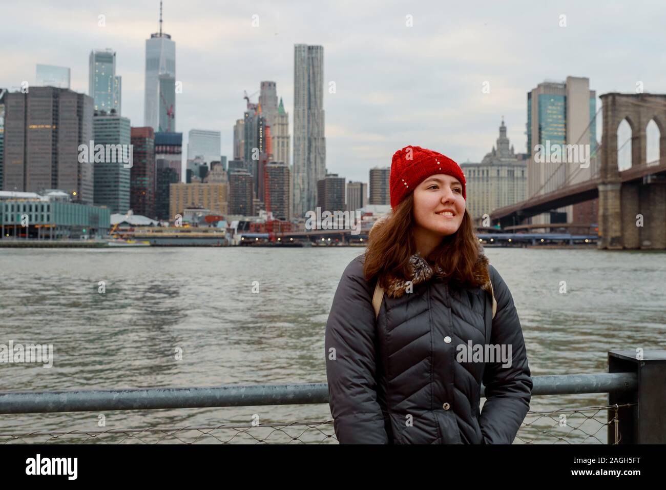 View from back of traveling beautiful young girl on Brooklyn Bridge ...