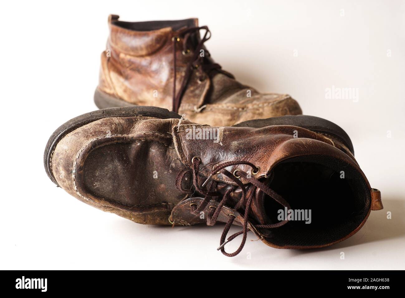 Photograph of man's dirty old leather boots on white background Stock ...