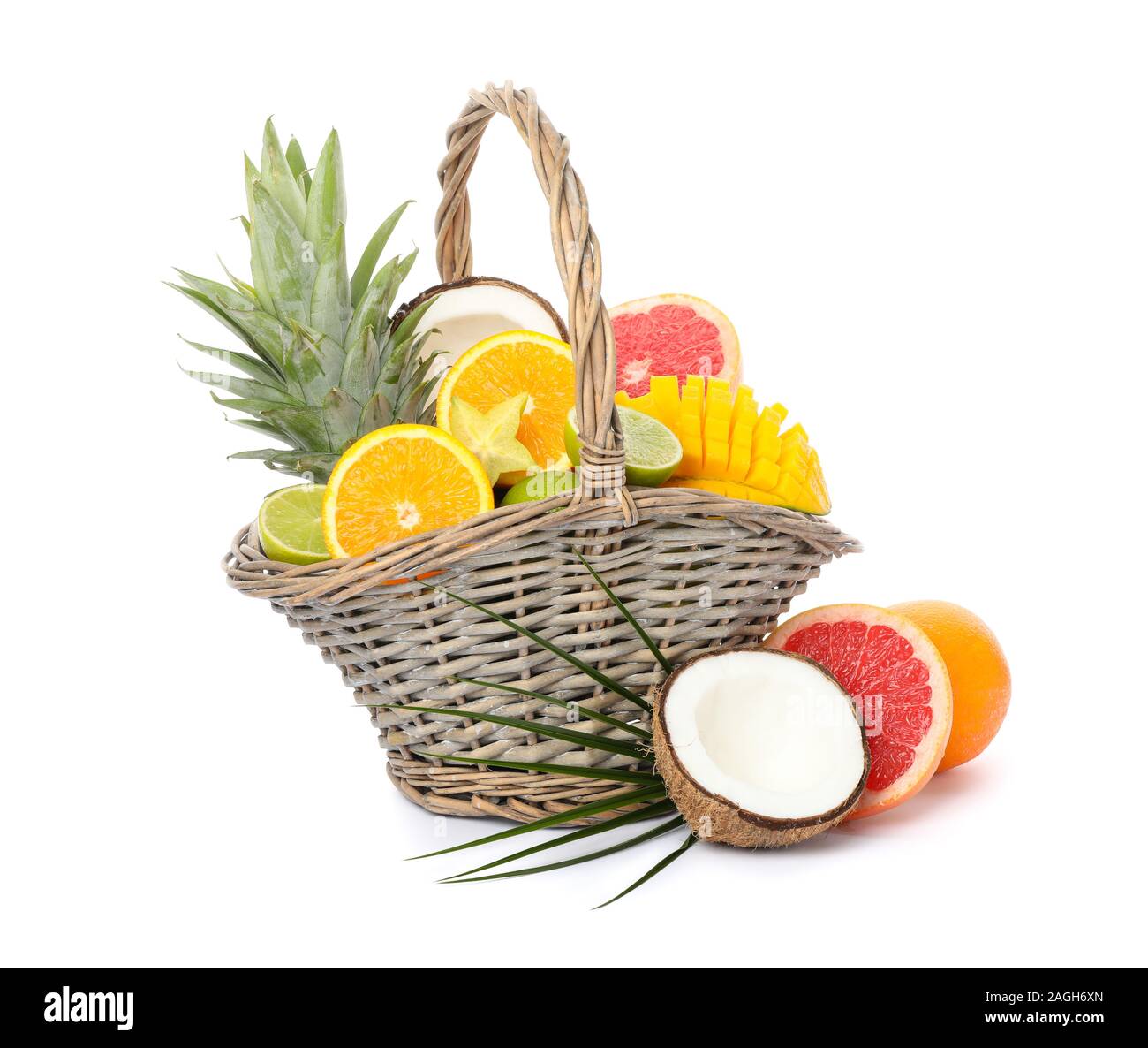 Wicker basket with exotic fruits isolated on white background Stock ...