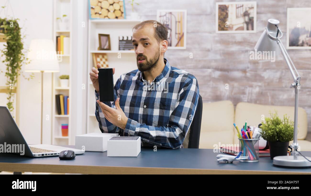 Famous influencer recording the unboxing of modern phone. Creative ...