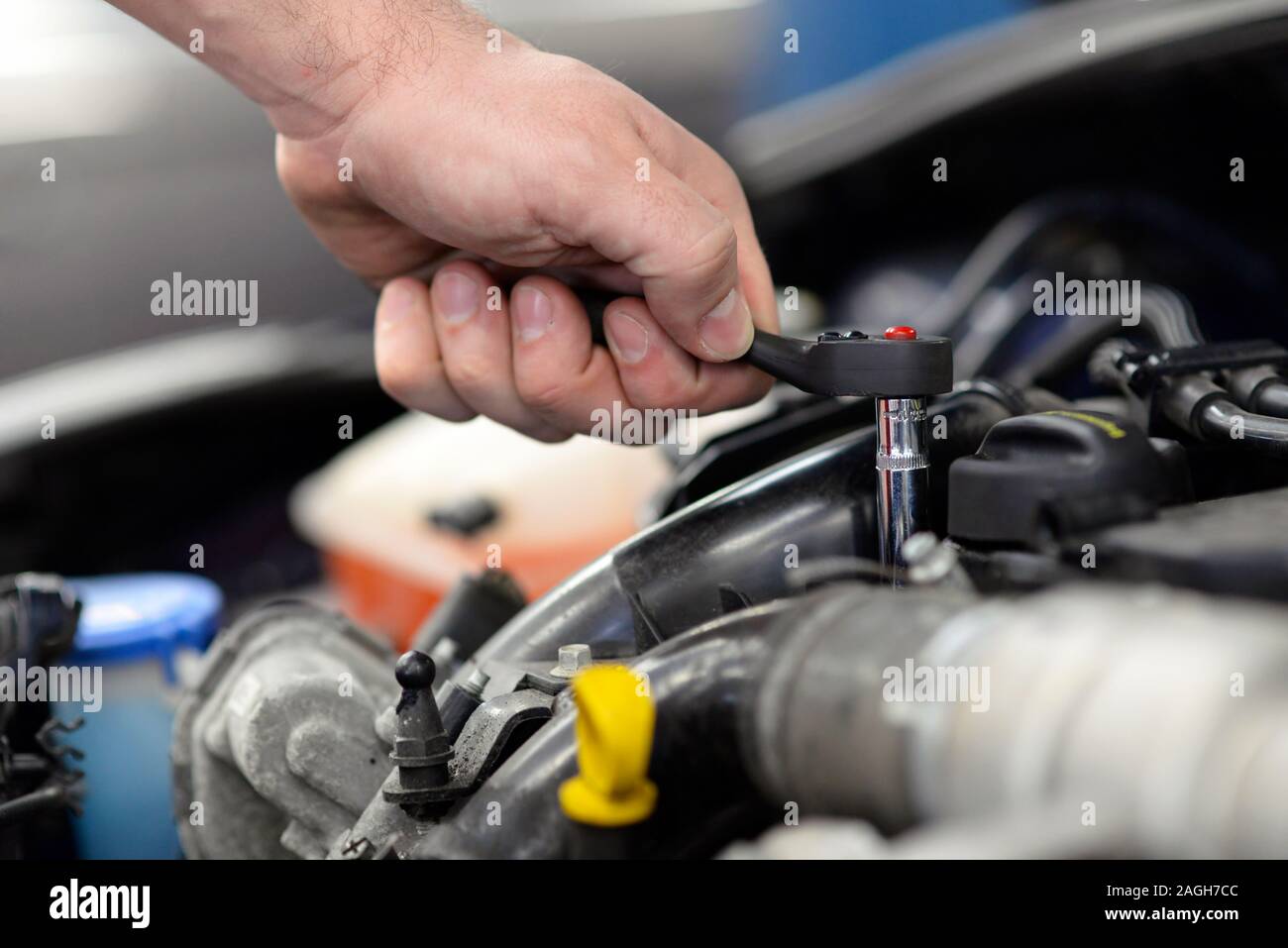 job and workplace - mechanic in a workshop repairing a car Stock Photo ...