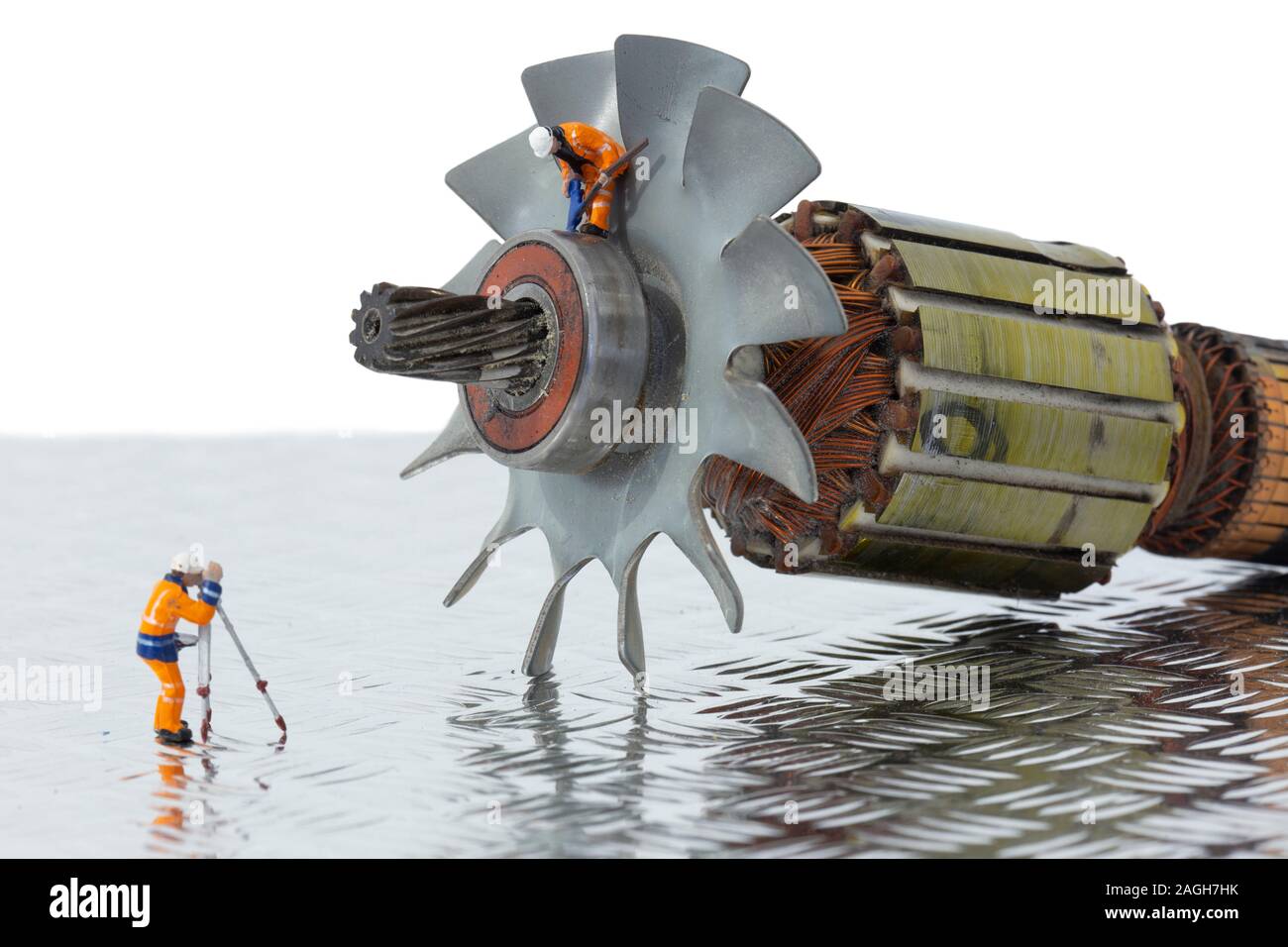 Miniature scale model construction workers with an industrial electric ...