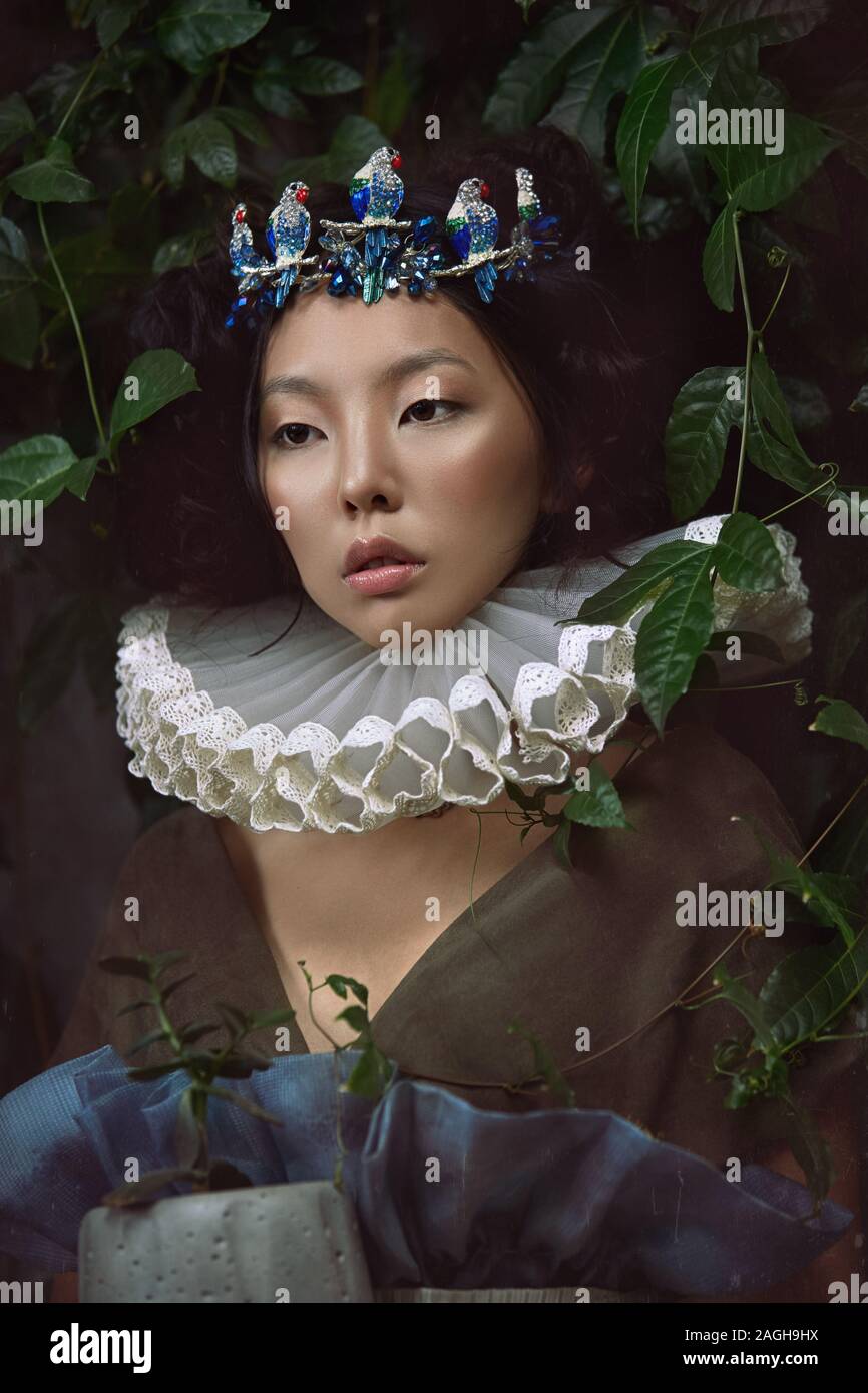 Art portrait of a girl Princess Queen in foliage and greenery, fabulous ...