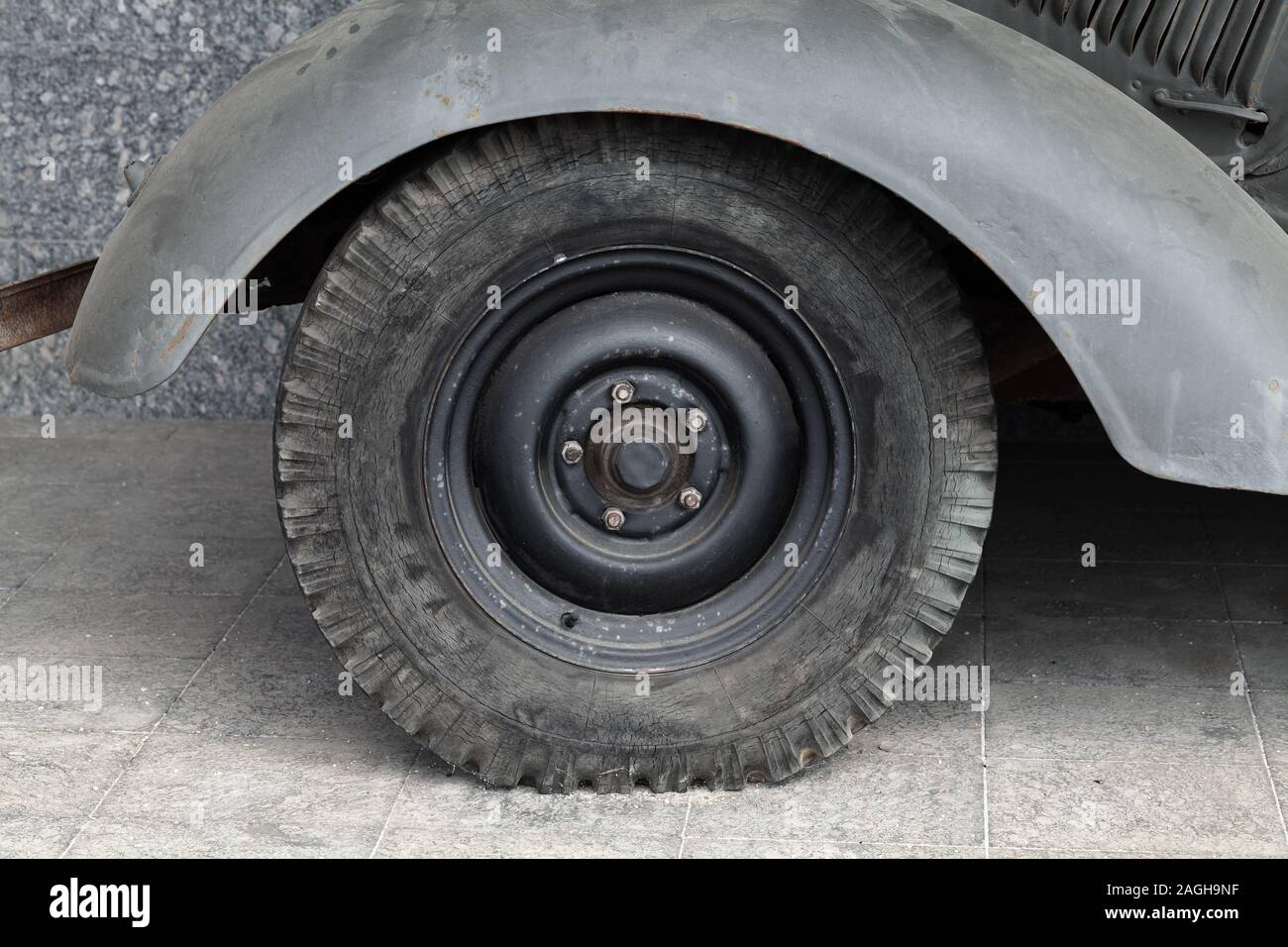 Close up photo of a black car wheel, old-timer vehicle from WWII period ...