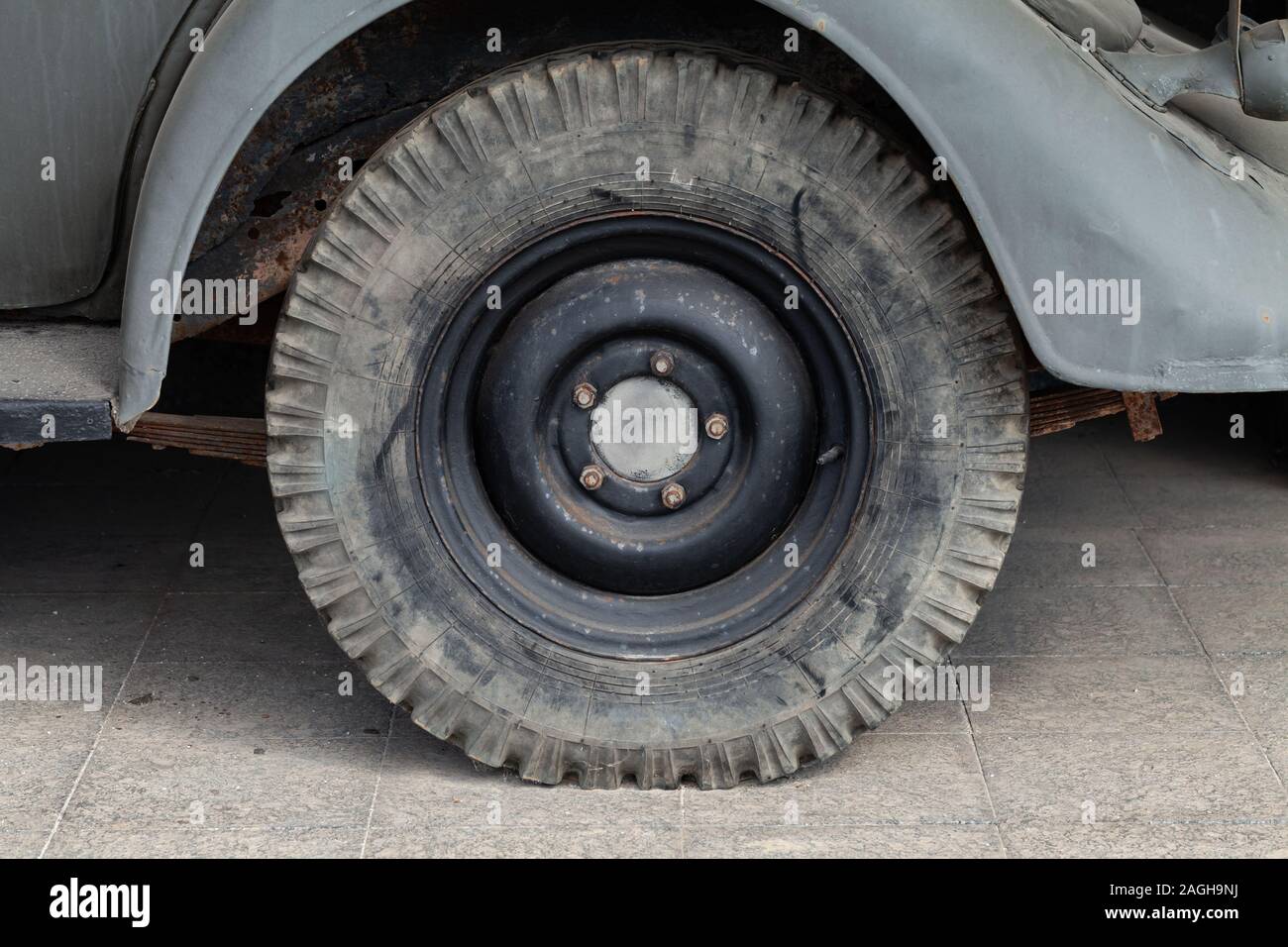 Black car wheel, old-timer vehicle from WWII period. Close up photo ...