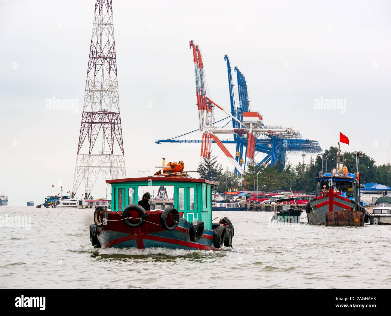 Small boats and industrial cranes, Haiphong port, Vietnam, Southeast ...