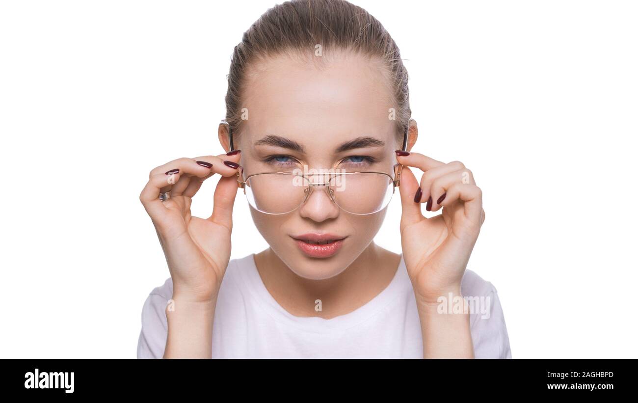 Young woman wearing glasses looking at camera with doubt and distrust ...