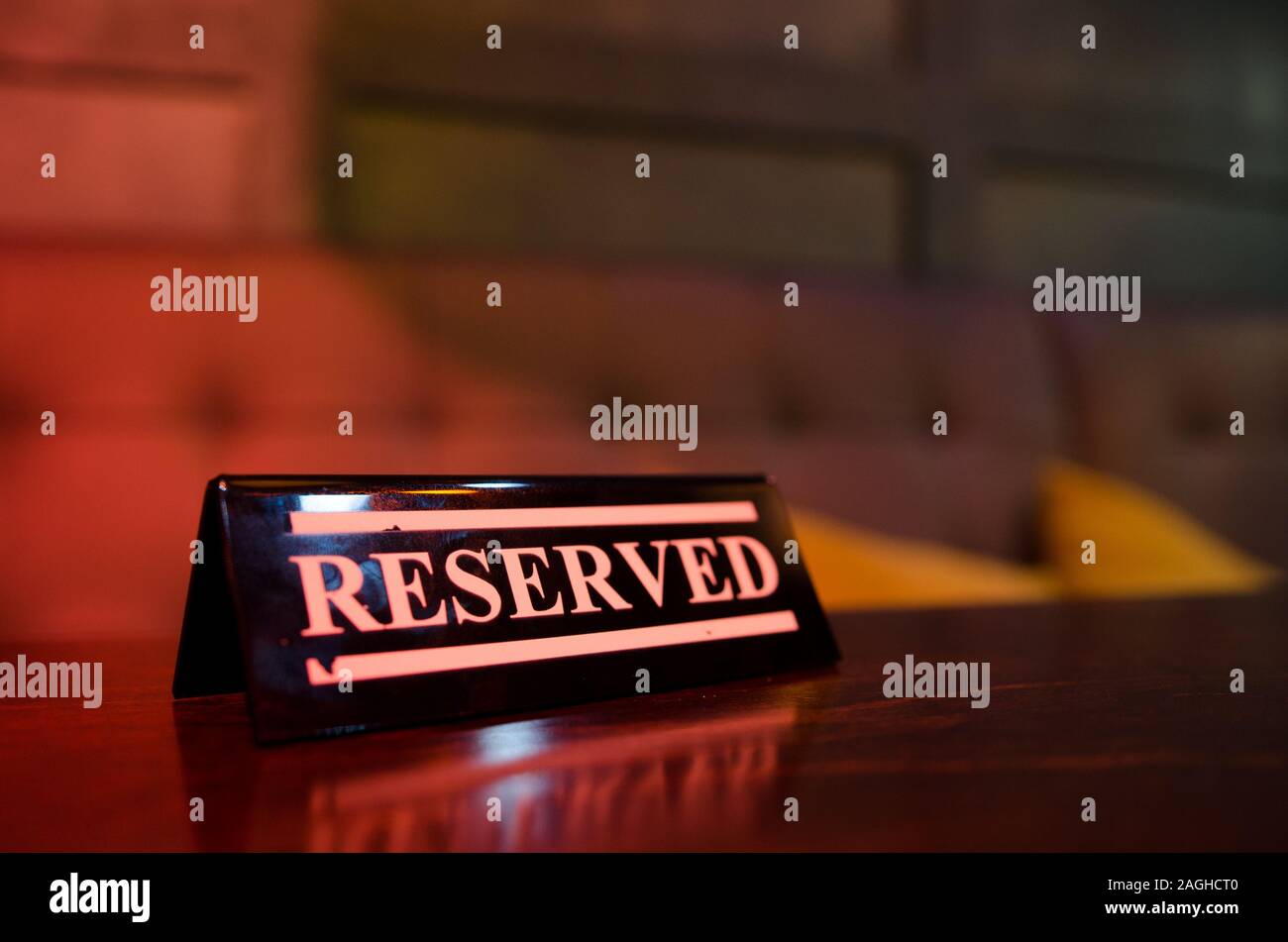 Black plastic signboard place on the wooden dining table. Restaurant ...