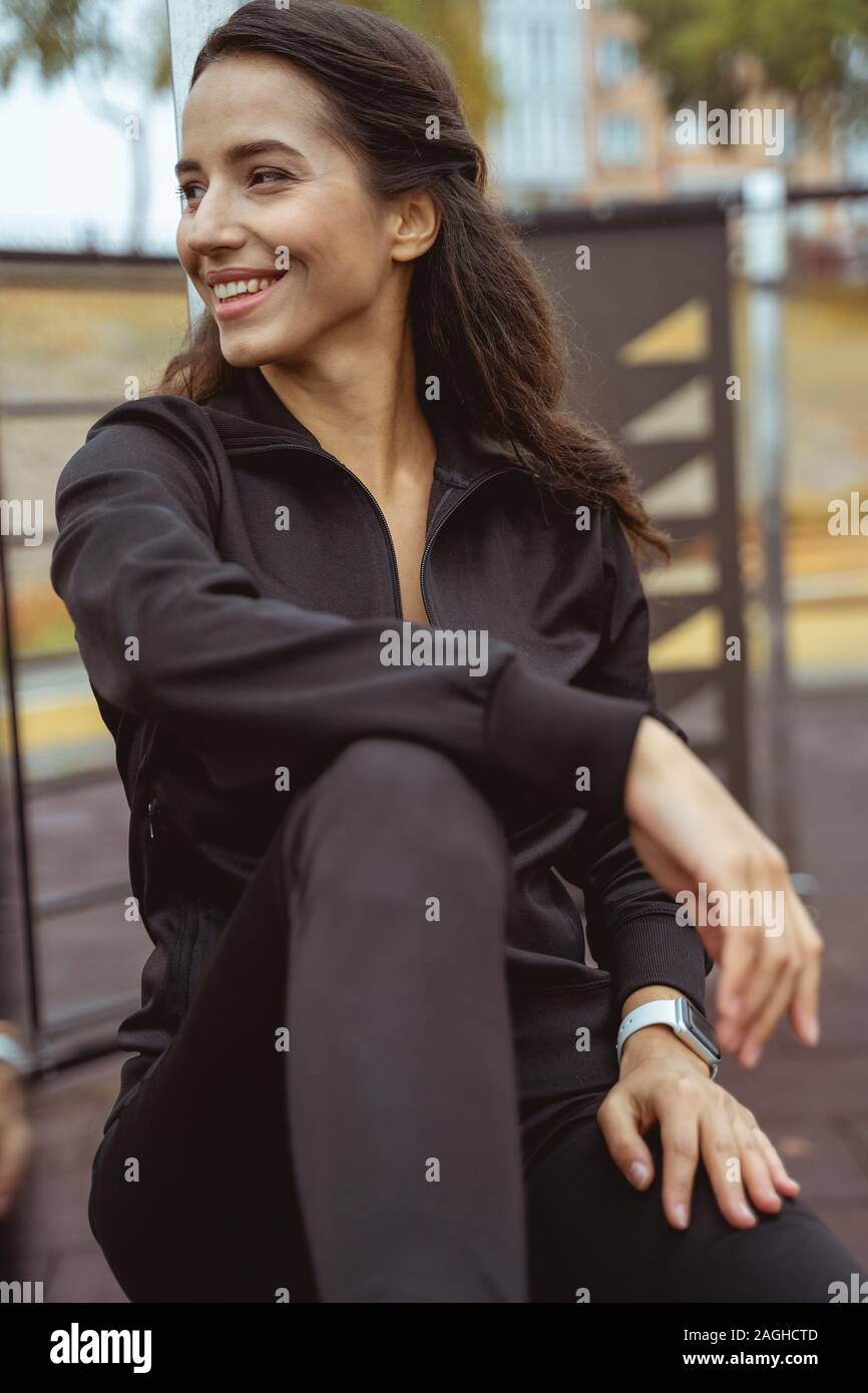 Charming young female having rest after run Stock Photo - Alamy
