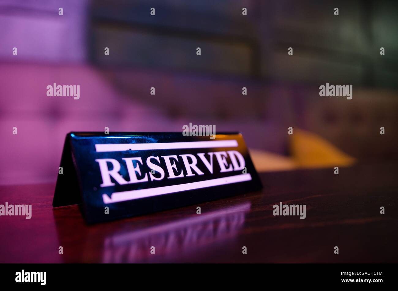 Restaurant reserved table sign. Interior of trendy cafe, copy space ...