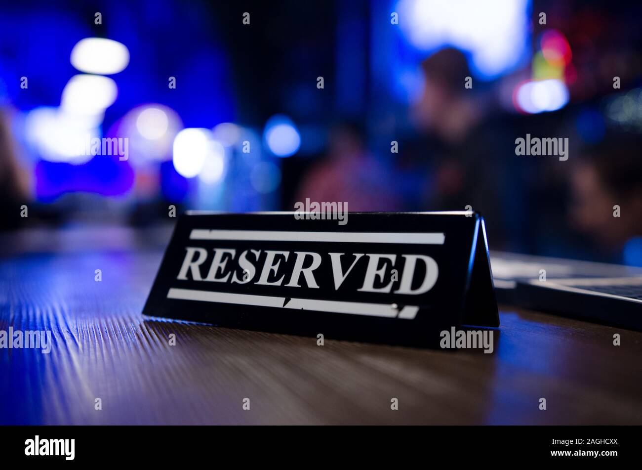 Restaurant reserved table sign. Interior of trendy cafe, copy space ...