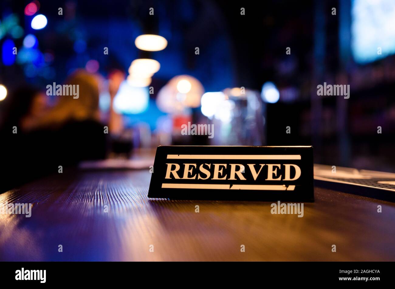 Reserved sign standing on wooden table in bar. Pub interior Stock Photo ...