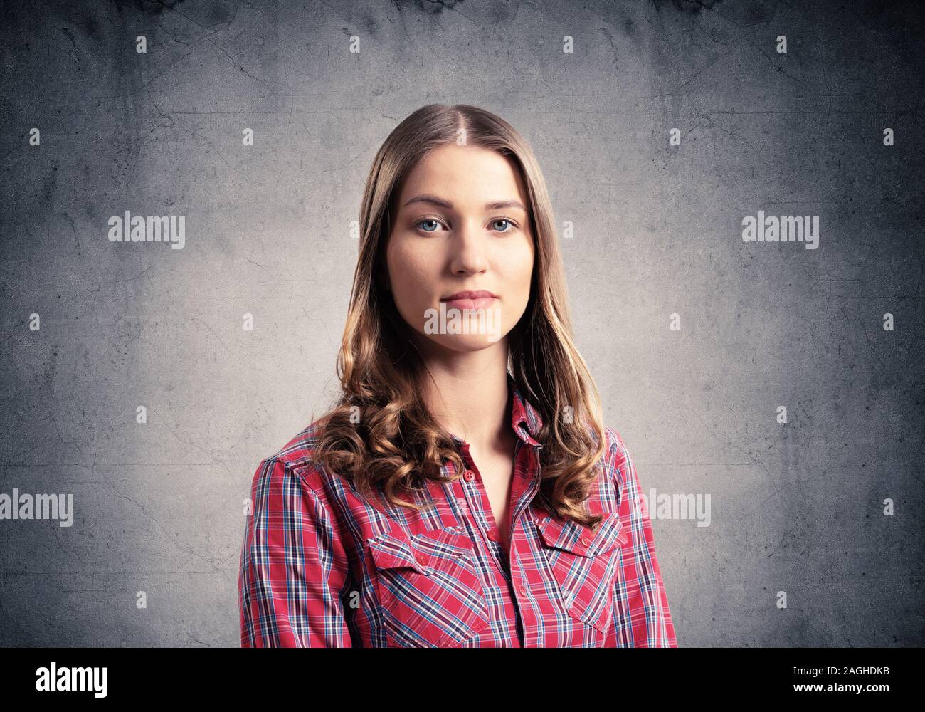 Young woman having serious and calm face Stock Photo - Alamy