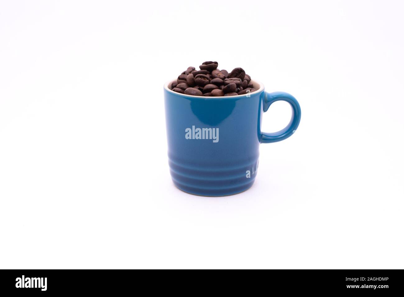 Coffee beans inside a mug isolated over white background Stock Photo ...
