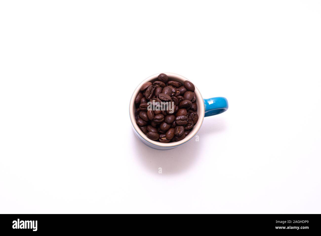 Coffee beans inside a mug isolated over white background Stock Photo ...