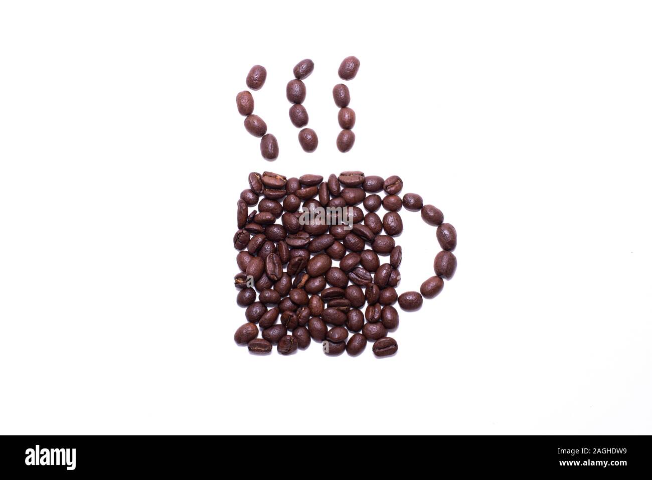 Cup of coffee shape created with coffee beans over a white background ...
