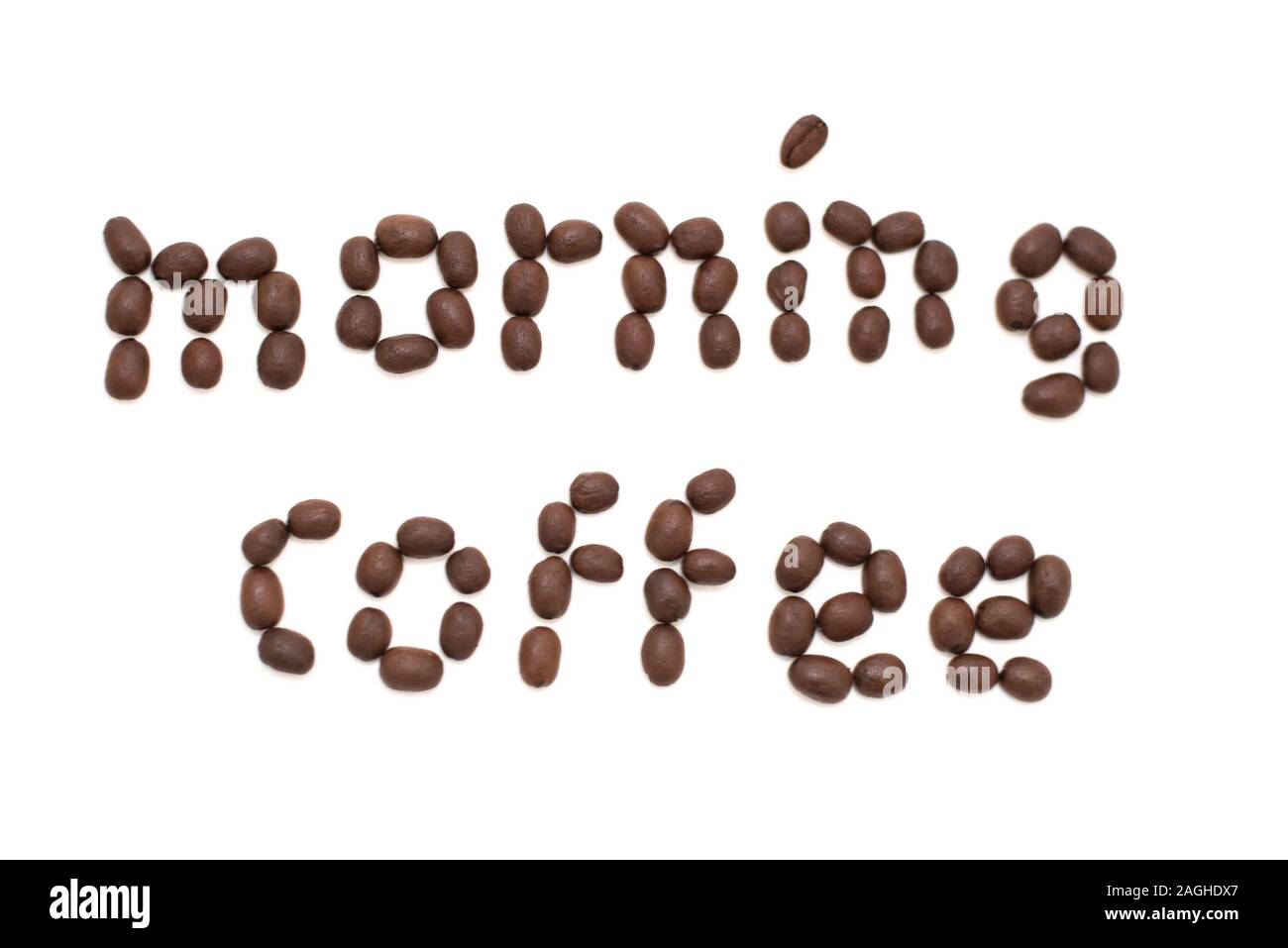 Words morning coffee created with coffee beans over a white background ...