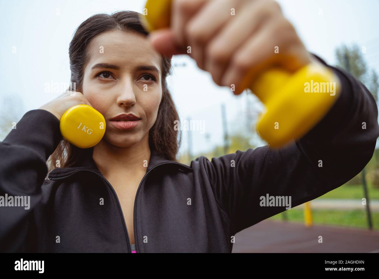 Cute young female doing sport alone outside Stock Photo - Alamy