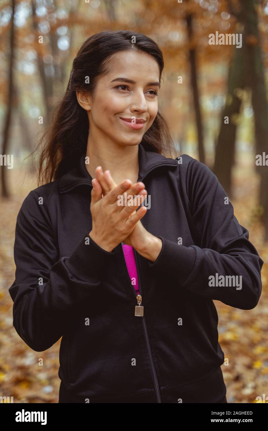 Portrait of pleased female that holding hands together Stock Photo - Alamy