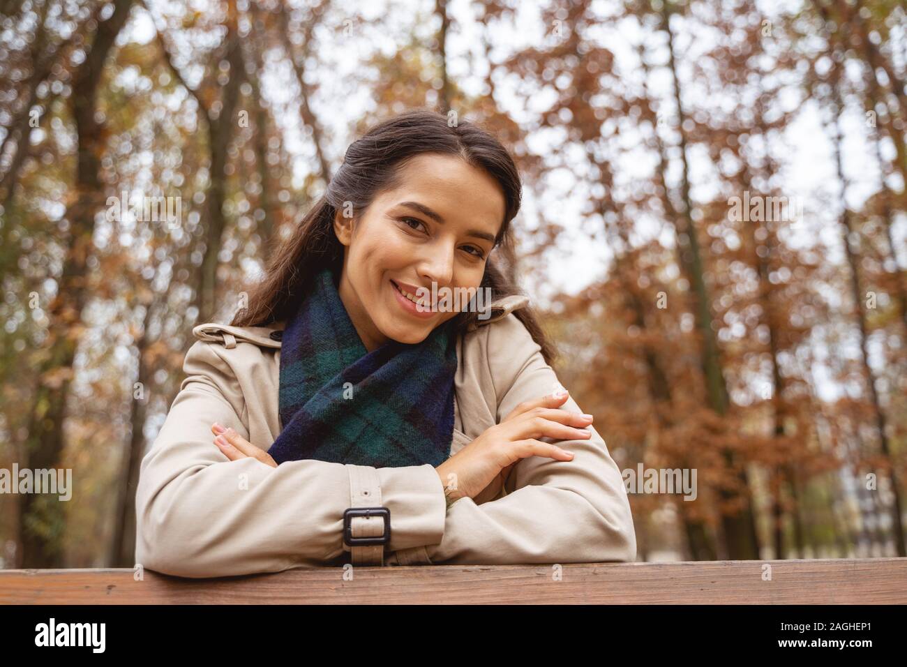 Beautiful young female leaning on the bench Stock Photo - Alamy