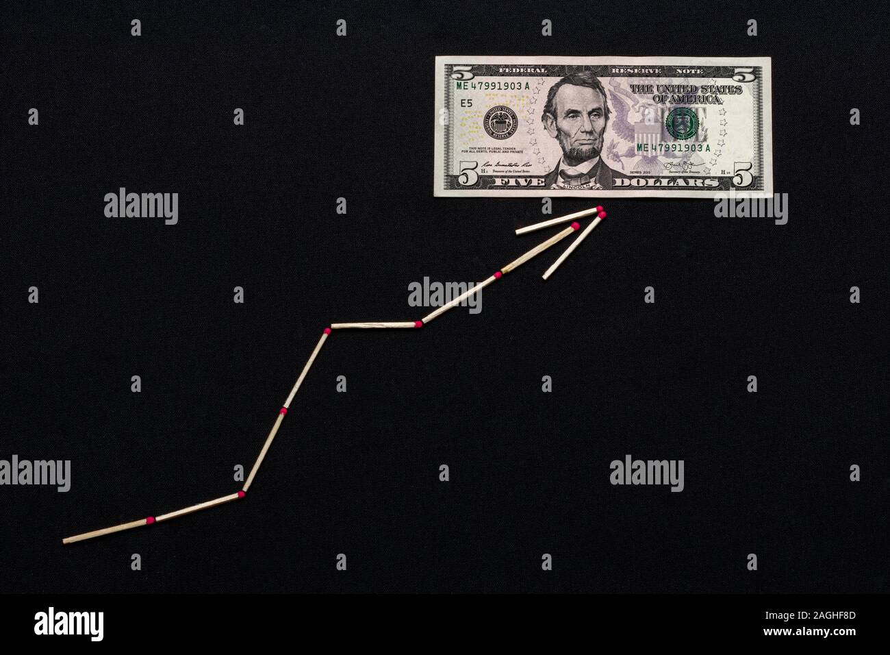 The white matchstick arrow shows the dollar rising on a black ...