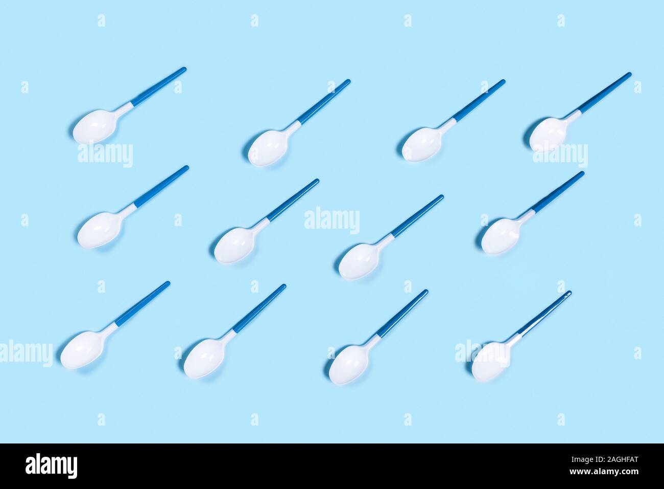 Group of white plastic spoons. Environmental problem of plastic rubbish ...