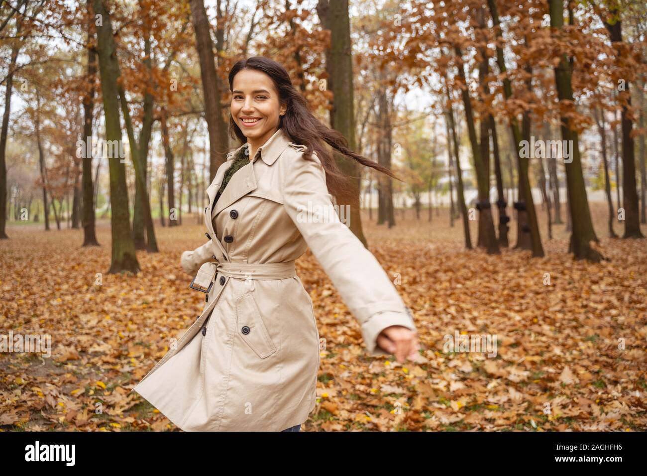 Joyful young woman walking with great pleasure Stock Photo - Alamy
