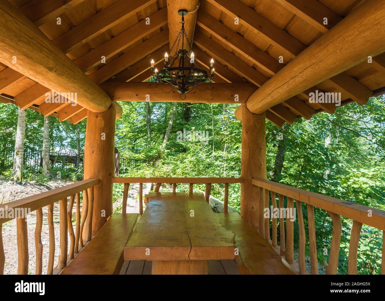 A table and two benches made of large solid wood in a log cabin Stock ...