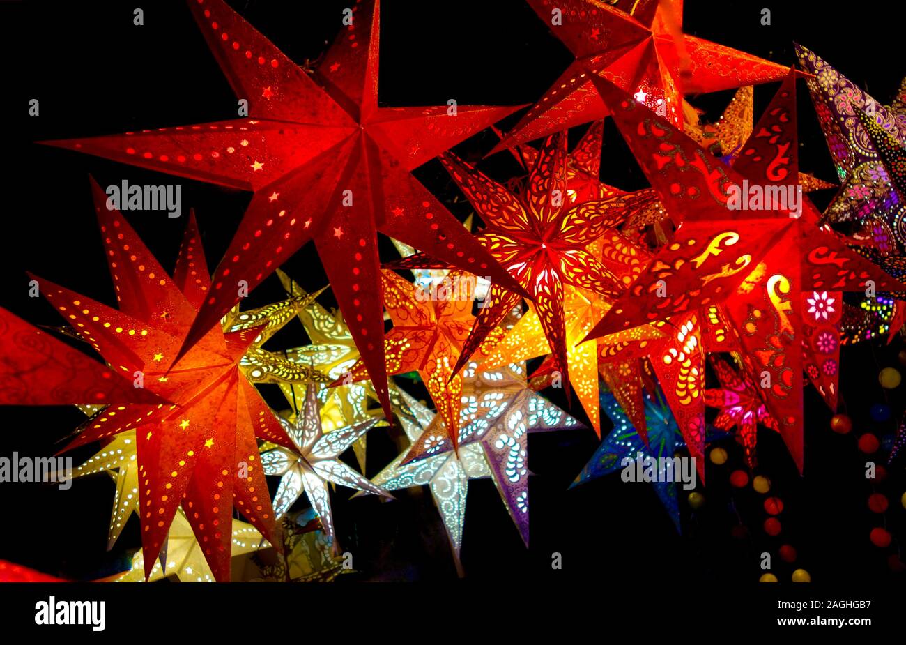 Colourful hanging stars on display at German Christmas market stall at ...