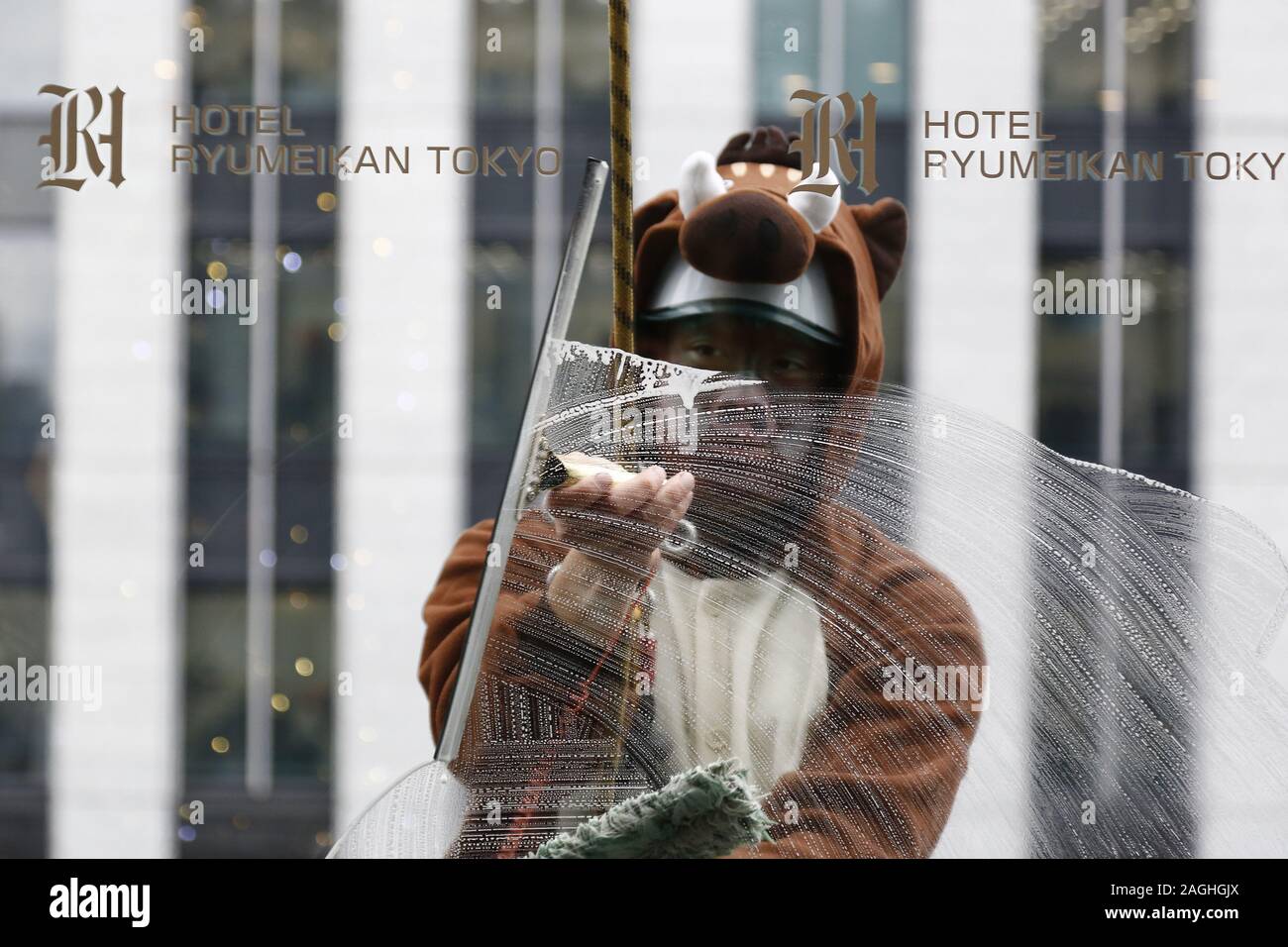 Tokyo, Japan. 19th Dec, 2019. A window cleaner dressed as a wild boar ...
