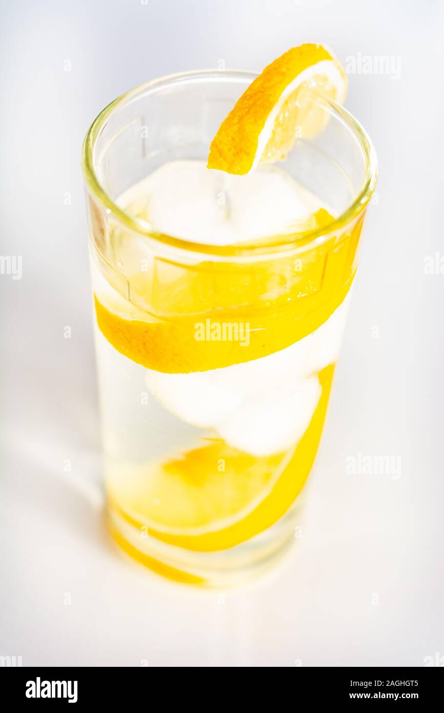 Glass of cold water with slices of ice and lemon Stock Photo - Alamy