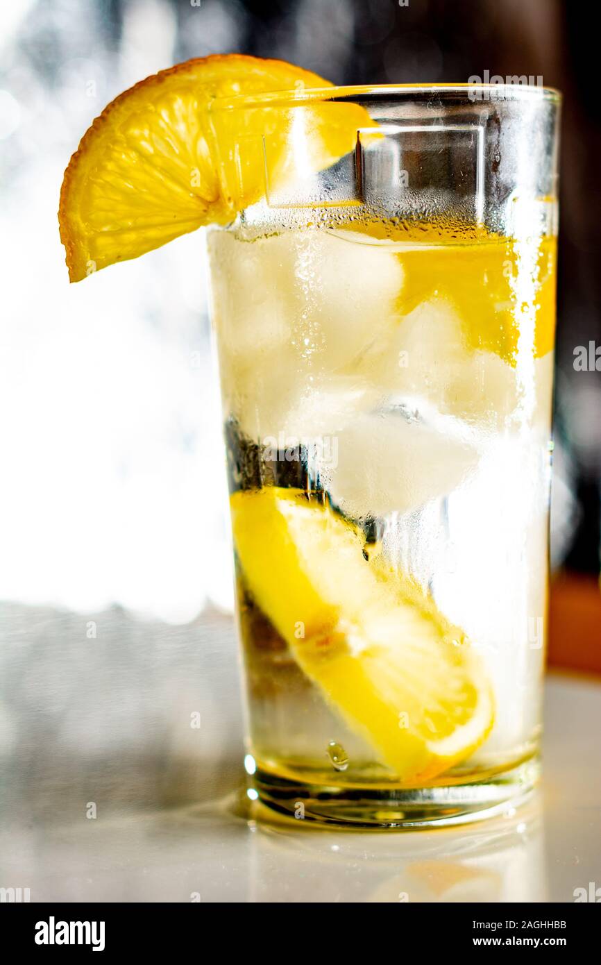 Glass of cold fresh water with slices of ice and lemon Stock Photo - Alamy