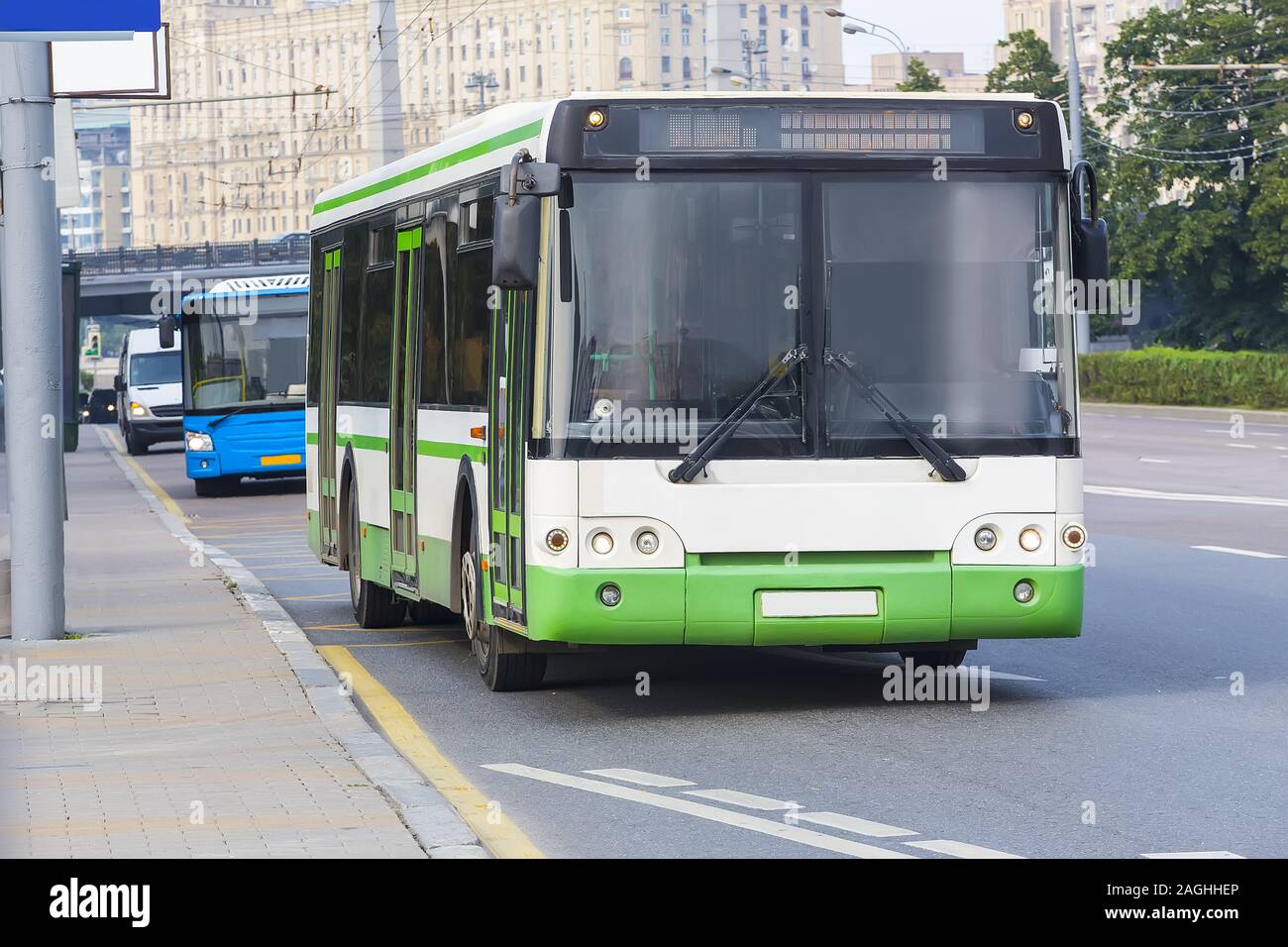 white city bus goes along street Stock Photo - Alamy