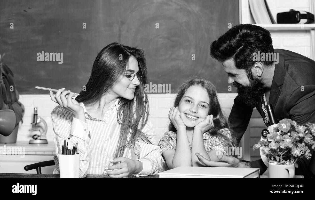 Mom and dad teachers helping child with learning. Smart family ...