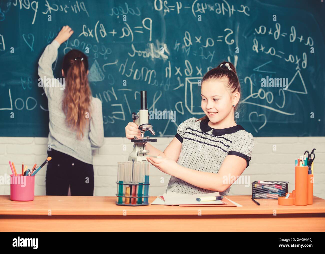Improving modern medicine. Little girls in school lab. Science is ...