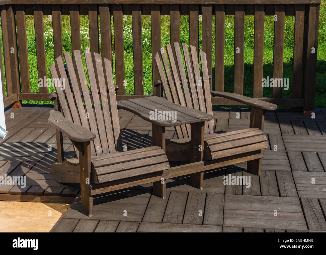 Two wooden chairs stand on the background of fence Stock Photo - Alamy