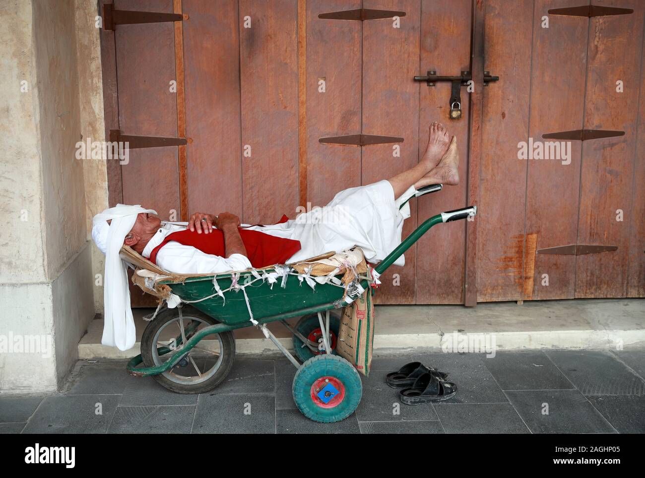 A local takes an afternoon nap in Doha, Qatar Stock Photo - Alamy