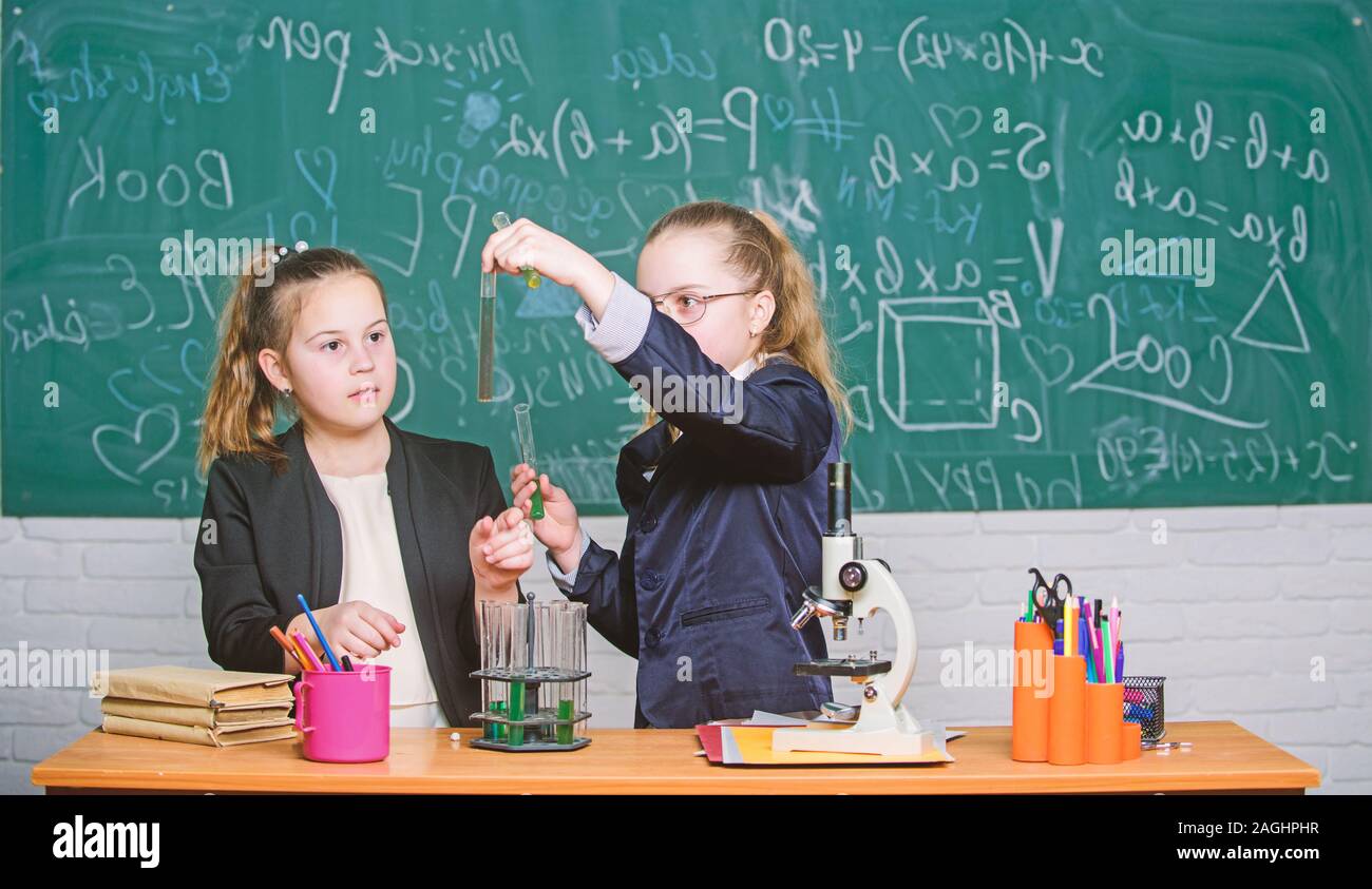 Little girls scientist work with microscope. Little girls in school lab ...